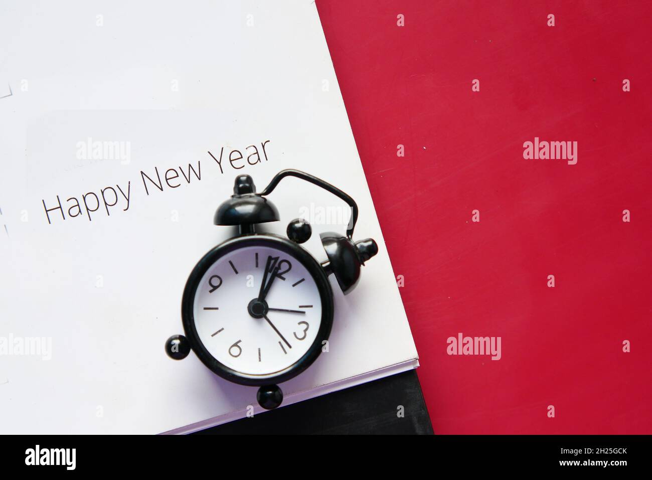 happy new year text on calendar with clock on table Stock Photo - Alamy
