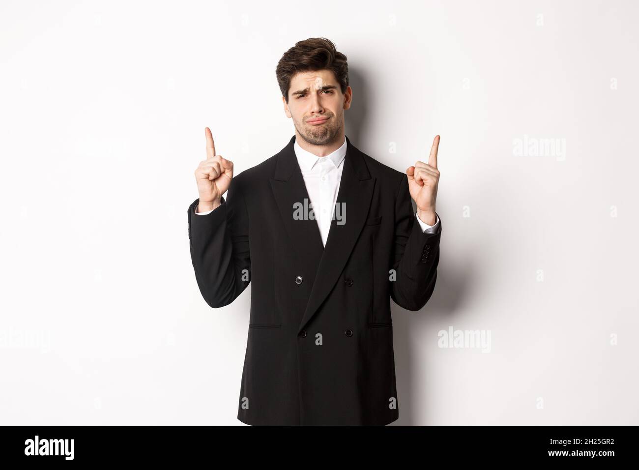 Portrait of reluctant and sad handsome man, complaining and pointing ...