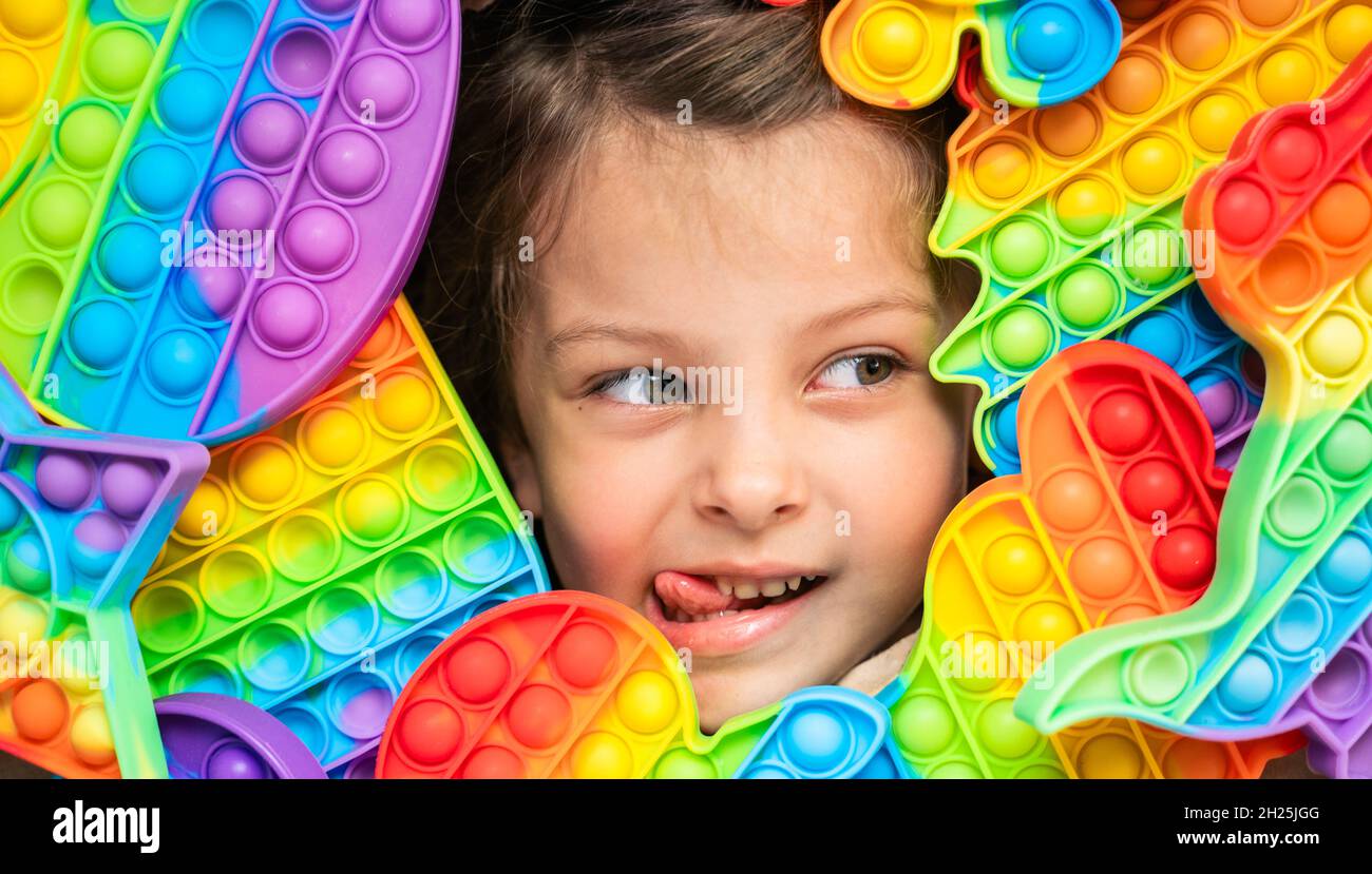 Little girl,kid,child head among many,lots of colorful pop it. Children ...