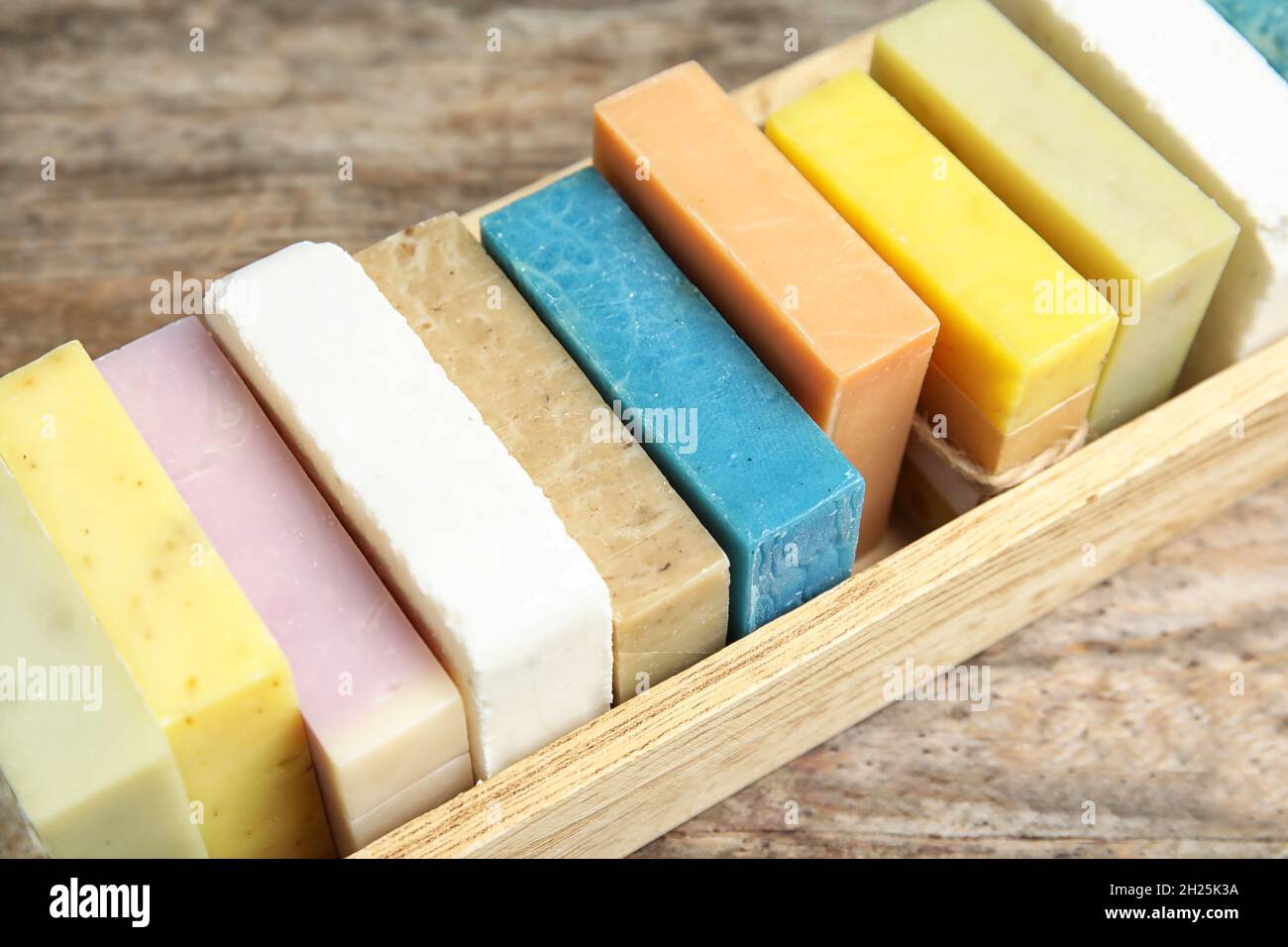 Many different handmade soap bars in wooden box on table, closeup Stock ...