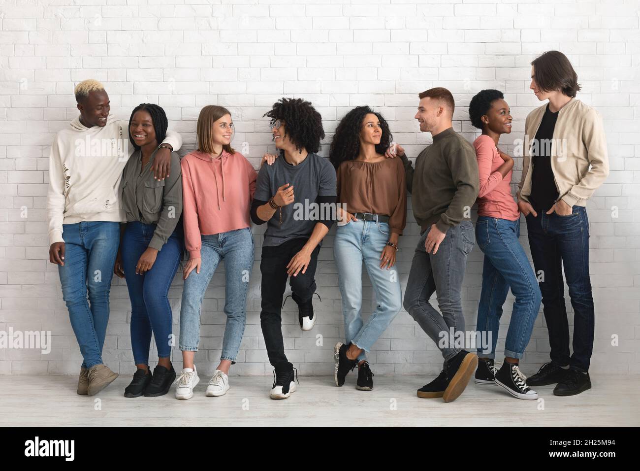 Carefree multiracial group of friends chilling together indoors Stock ...