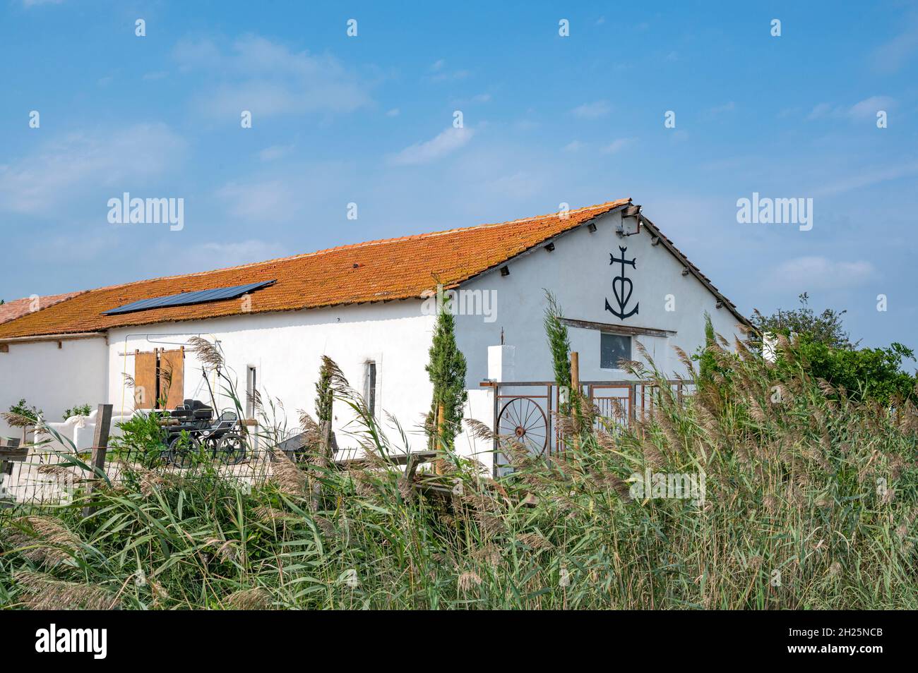 A "mas" farmhouse with the cross of the Camargue - house and cross are ...