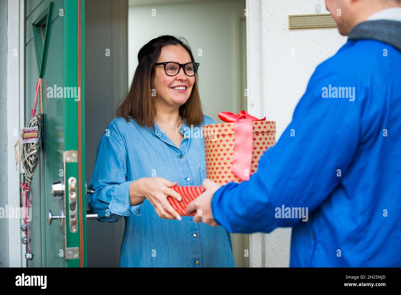 Happy woman receiving package hi-res stock photography and images - Alamy