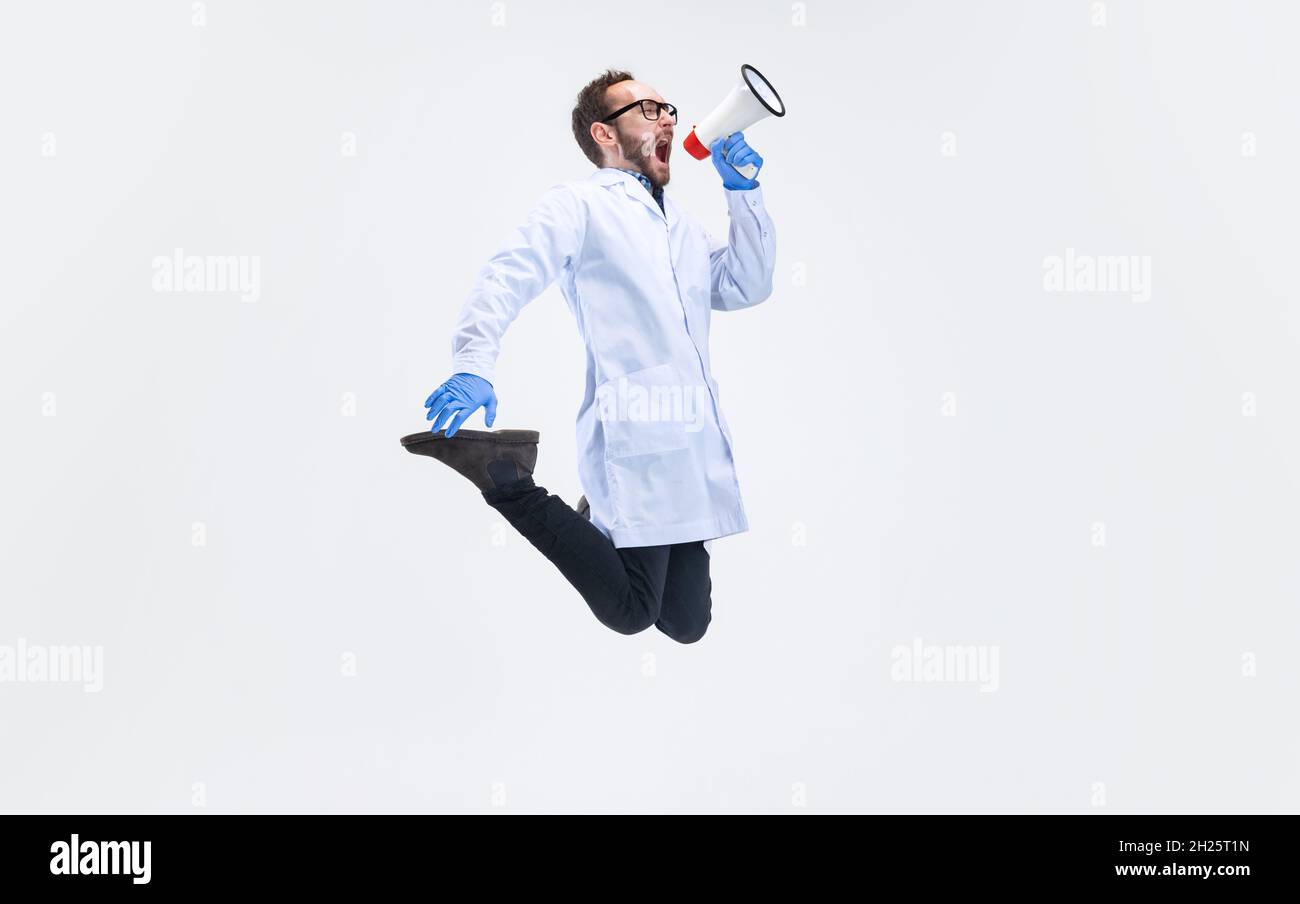 One excited man, chemist, doctor jumping and shouting at megaphone ...