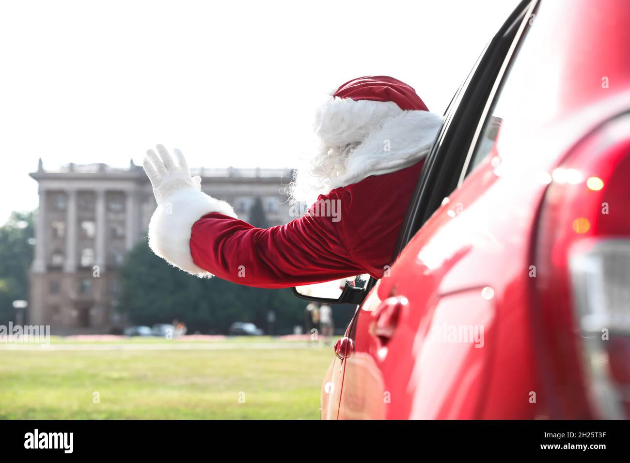Authentic Santa Claus leaning out of car window, view from outside ...