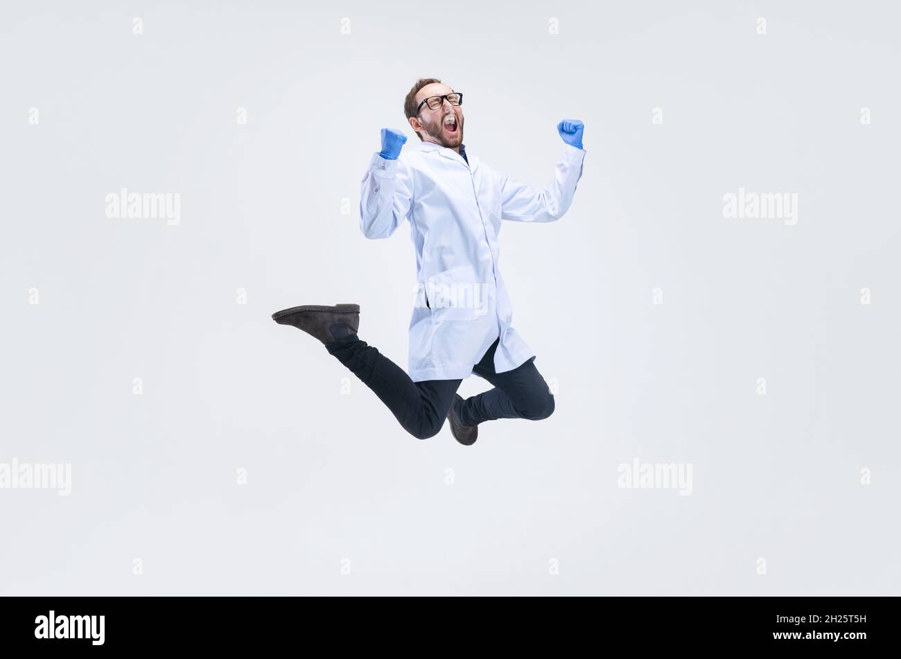One excited man, chemist, doctor jumping high and joy isolated on white ...