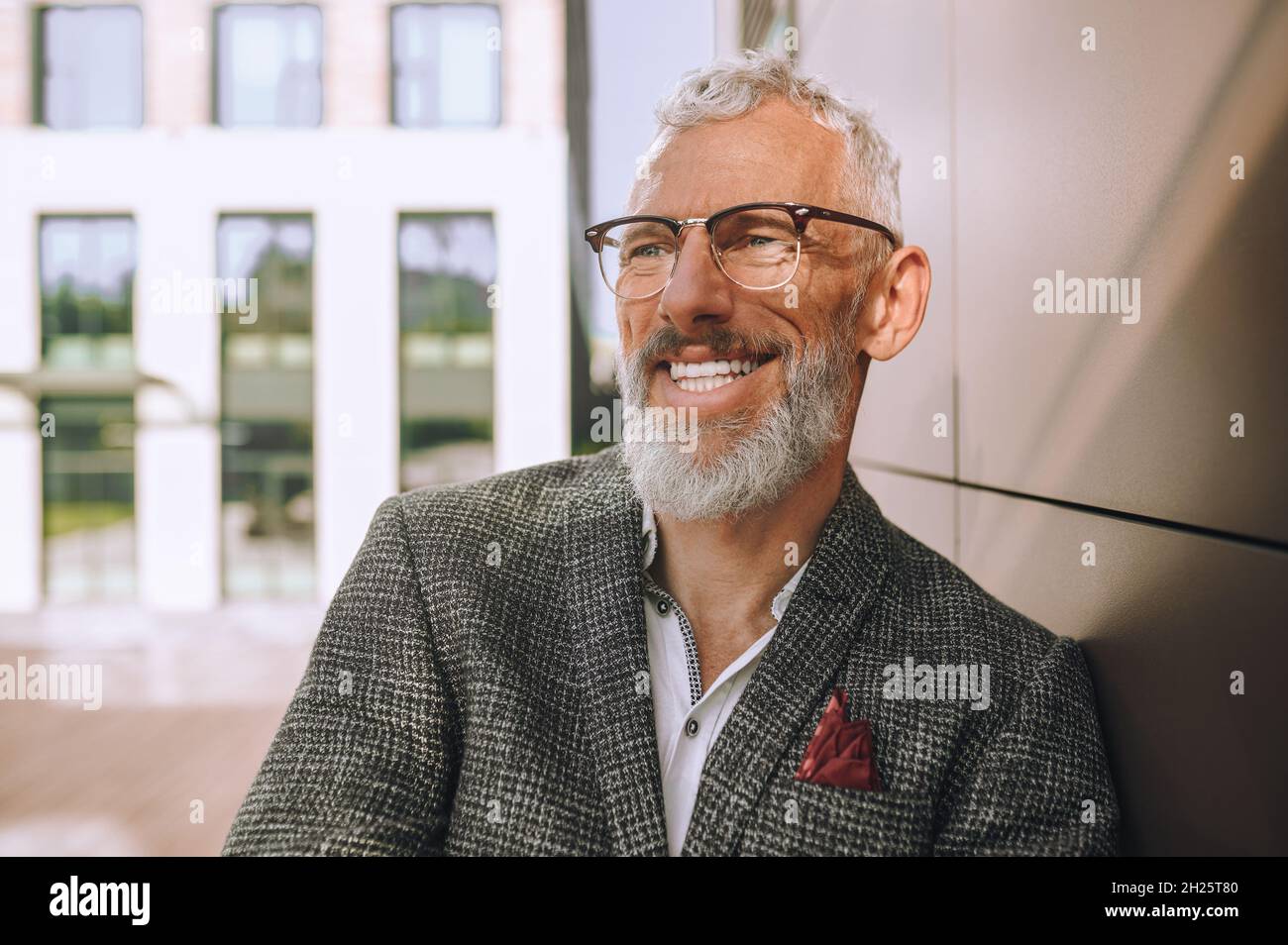 Businessman leaning against office wall hi-res stock photography and ...