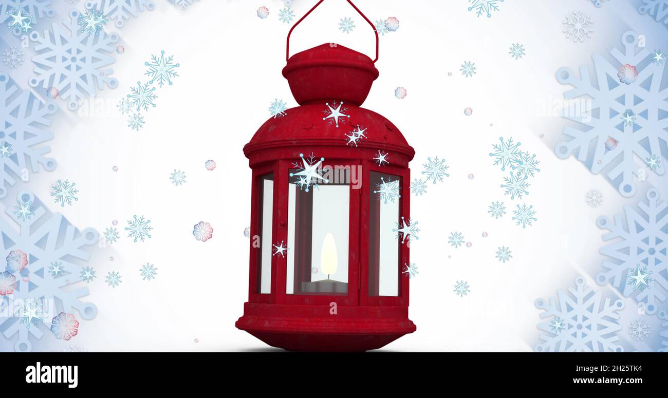 Image of snow falling over christmas lantern Stock Photo - Alamy