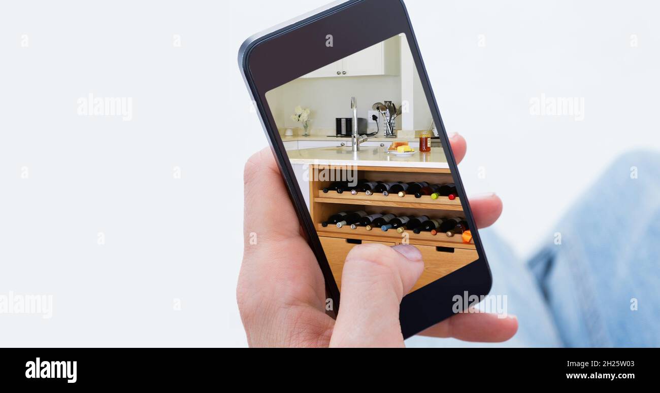 Person holding smartphone with modern kitchen interiors displayed on ...