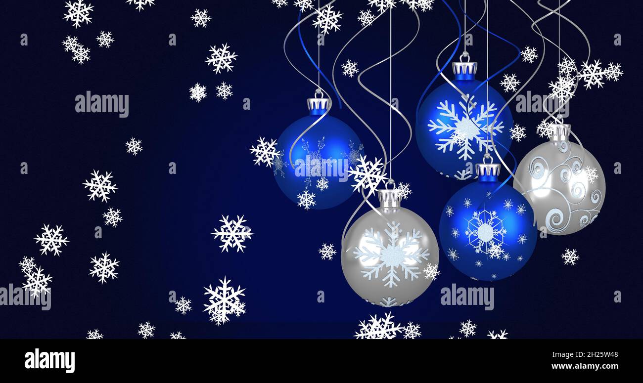 Image of baubles and snow falling on dark blue background Stock Photo ...