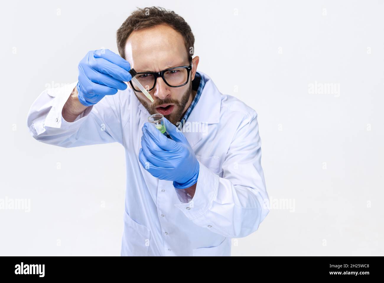 High angle view of young chemist, doctor conducts chemical research ...