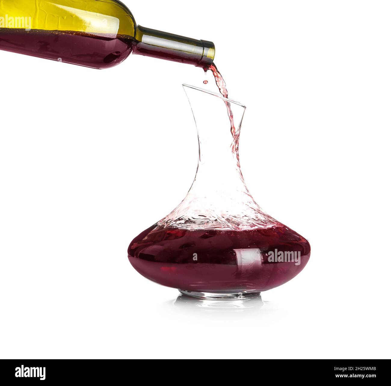 Pouring red wine into elegant decanter on white background Stock Photo ...