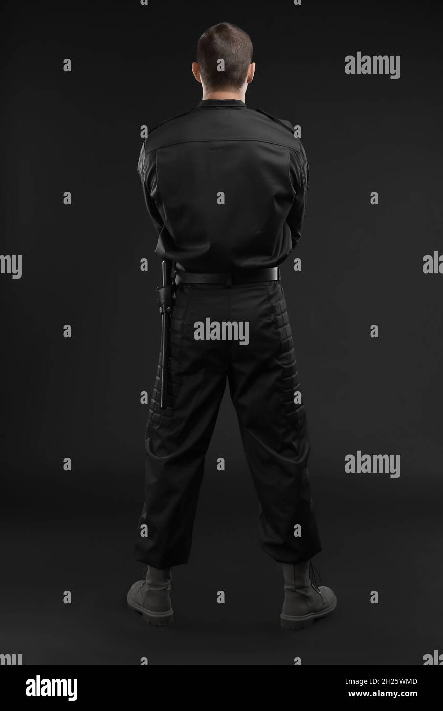 Male security guard in uniform on dark background Stock Photo - Alamy