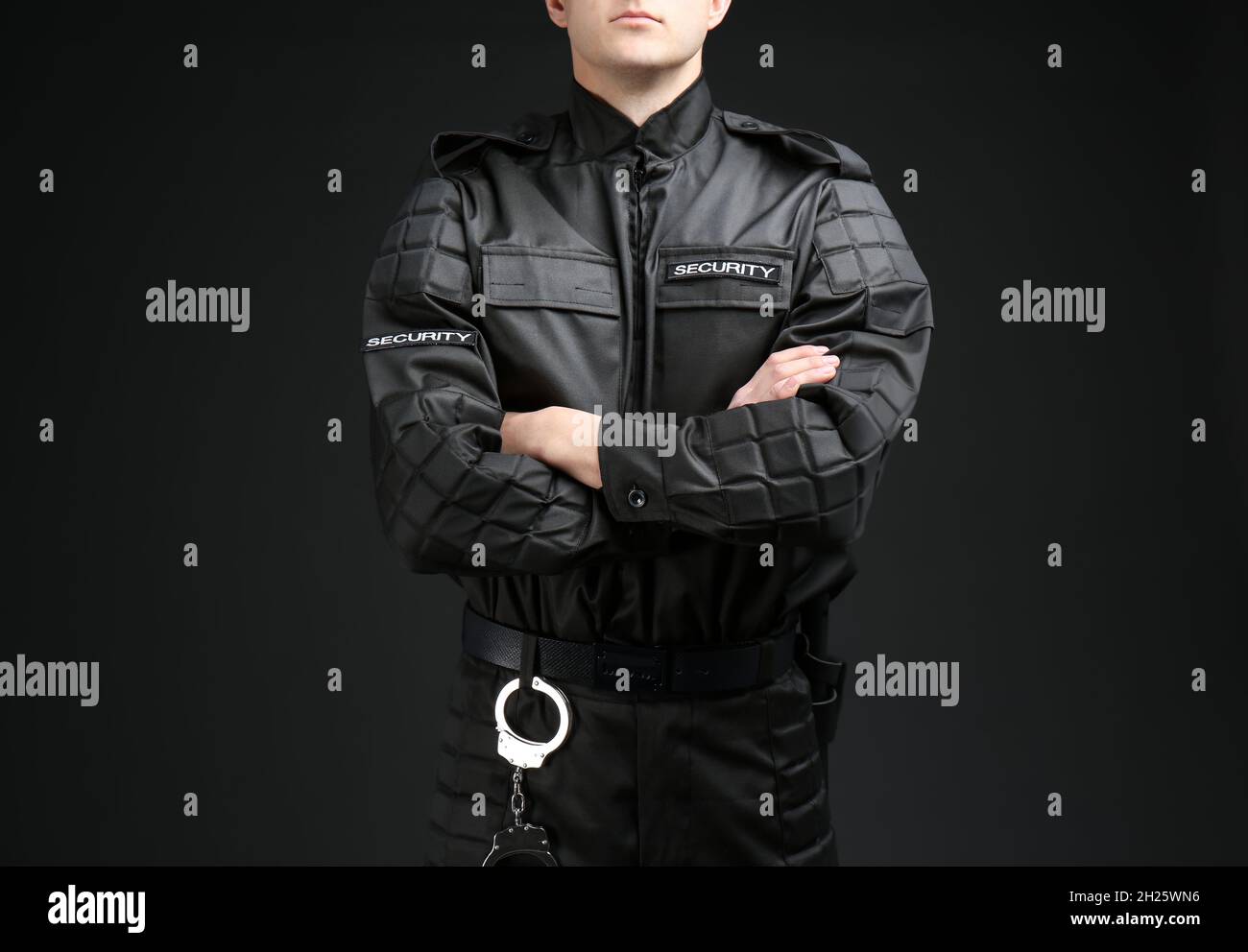 Male security guard in uniform on dark background Stock Photo - Alamy