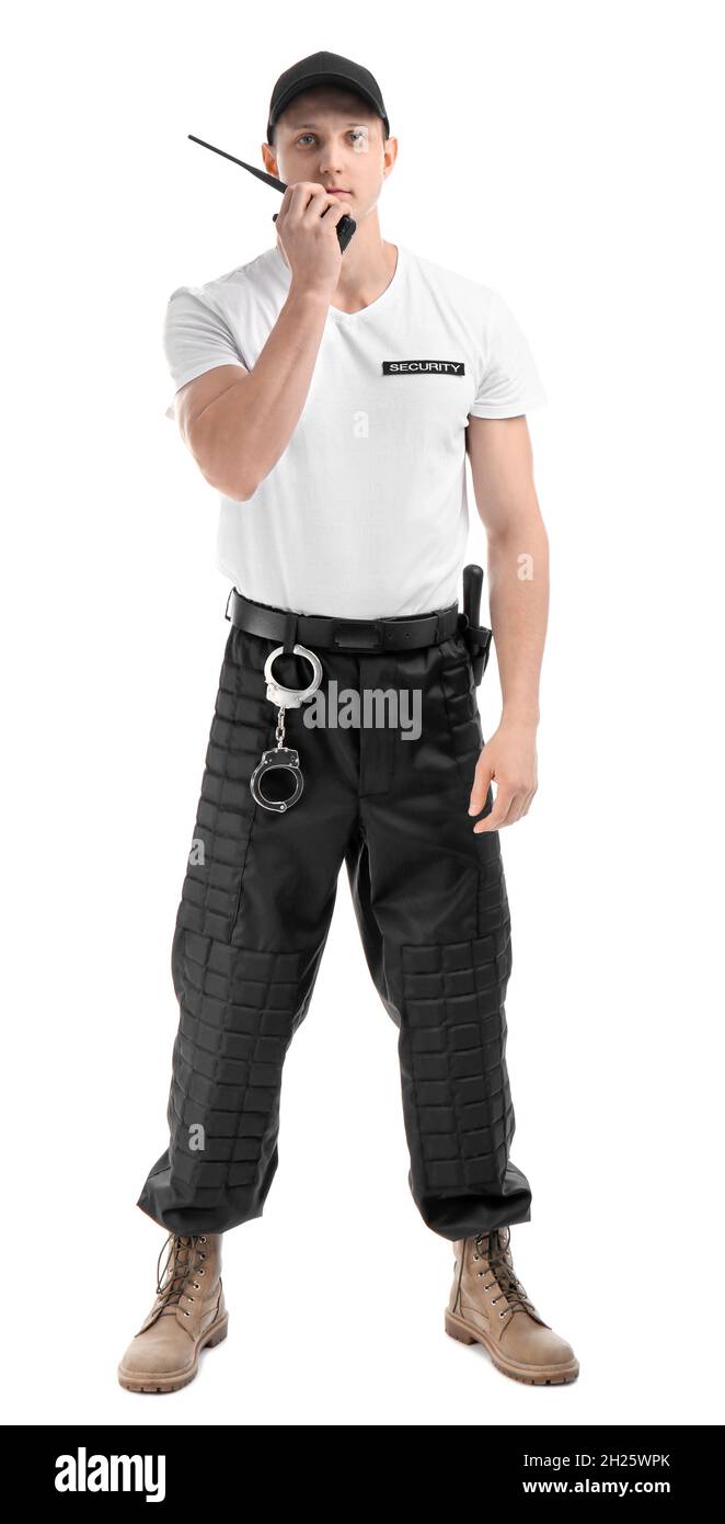 Male security guard using portable radio transmitter on white ...