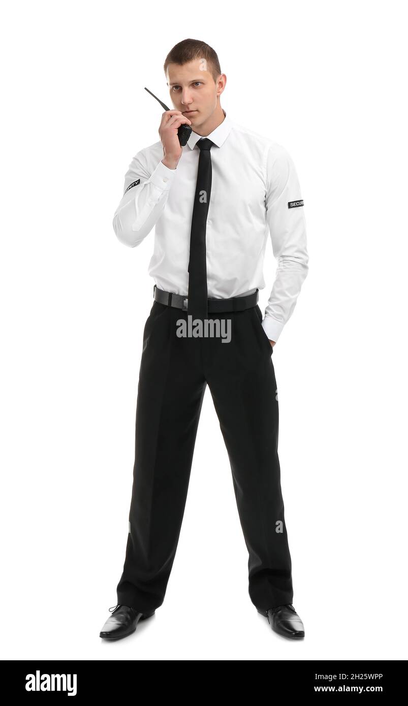 Male security guard using portable radio transmitter on white ...