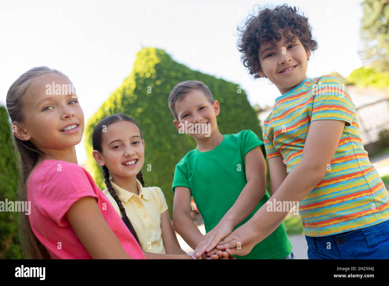 Happy children holding hands as sign of strong friendship Stock Photo ...