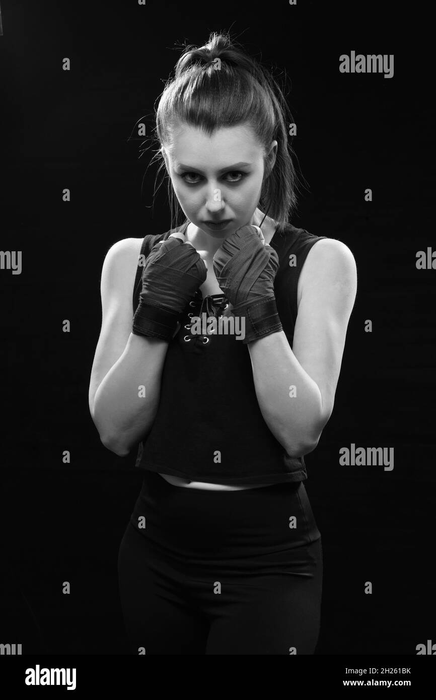 Angry Muay Thai female boxer in attack pose. Fitness young woman boxing ...