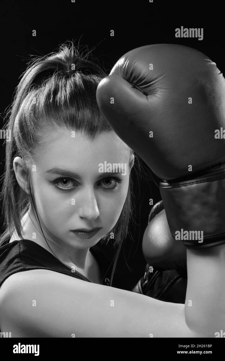 Angry Muay Thai female boxer in attack pose. Fitness young woman boxing ...