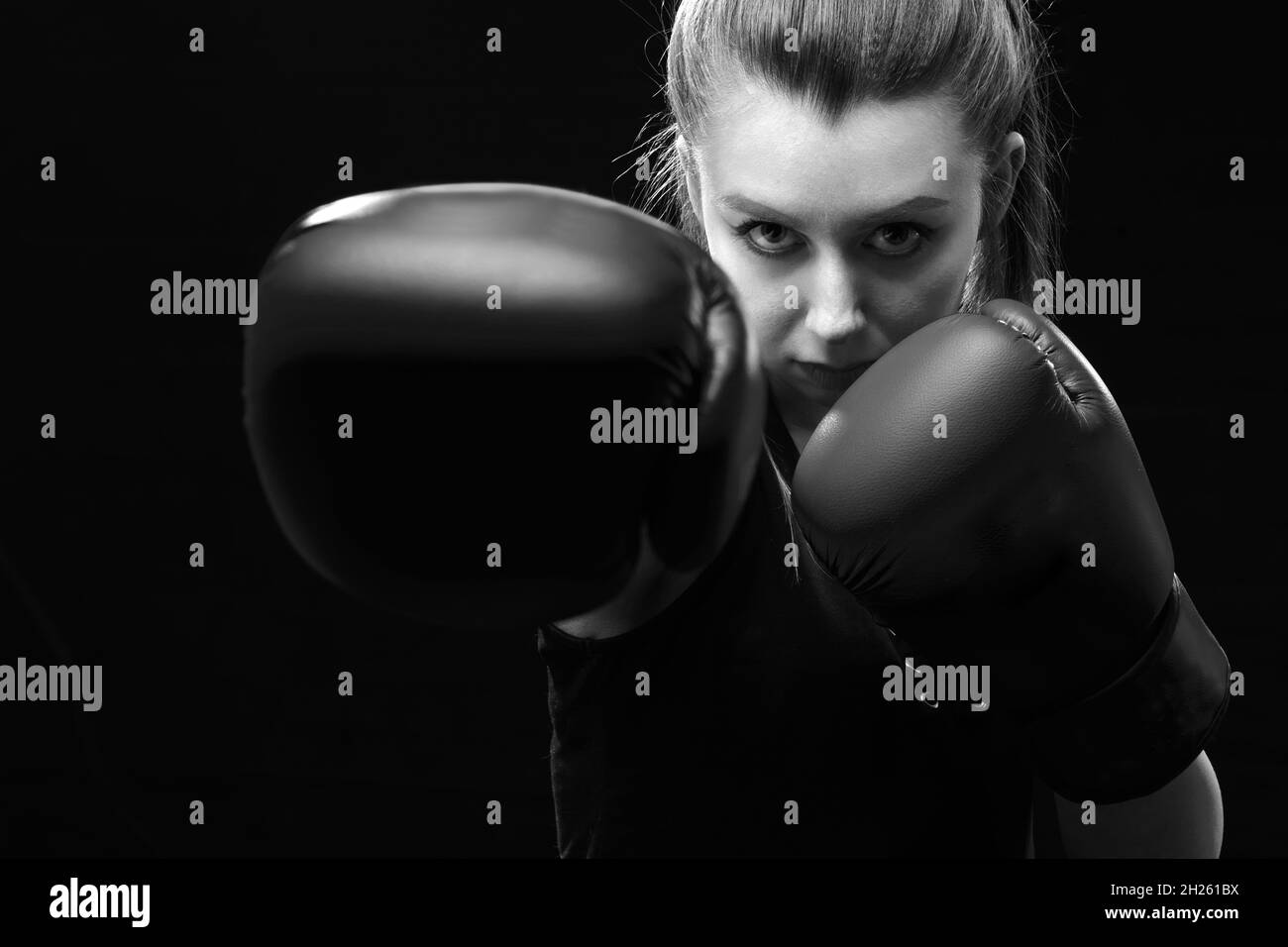 Angry Muay Thai female boxer in attack pose. Fitness young woman boxing ...