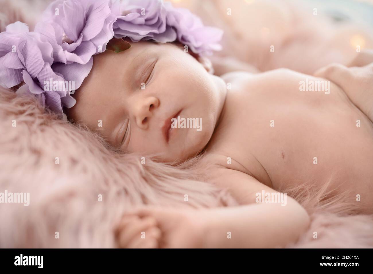 Adorable newborn baby girl with floral headband sleeping on bed Stock Photo - Alamy