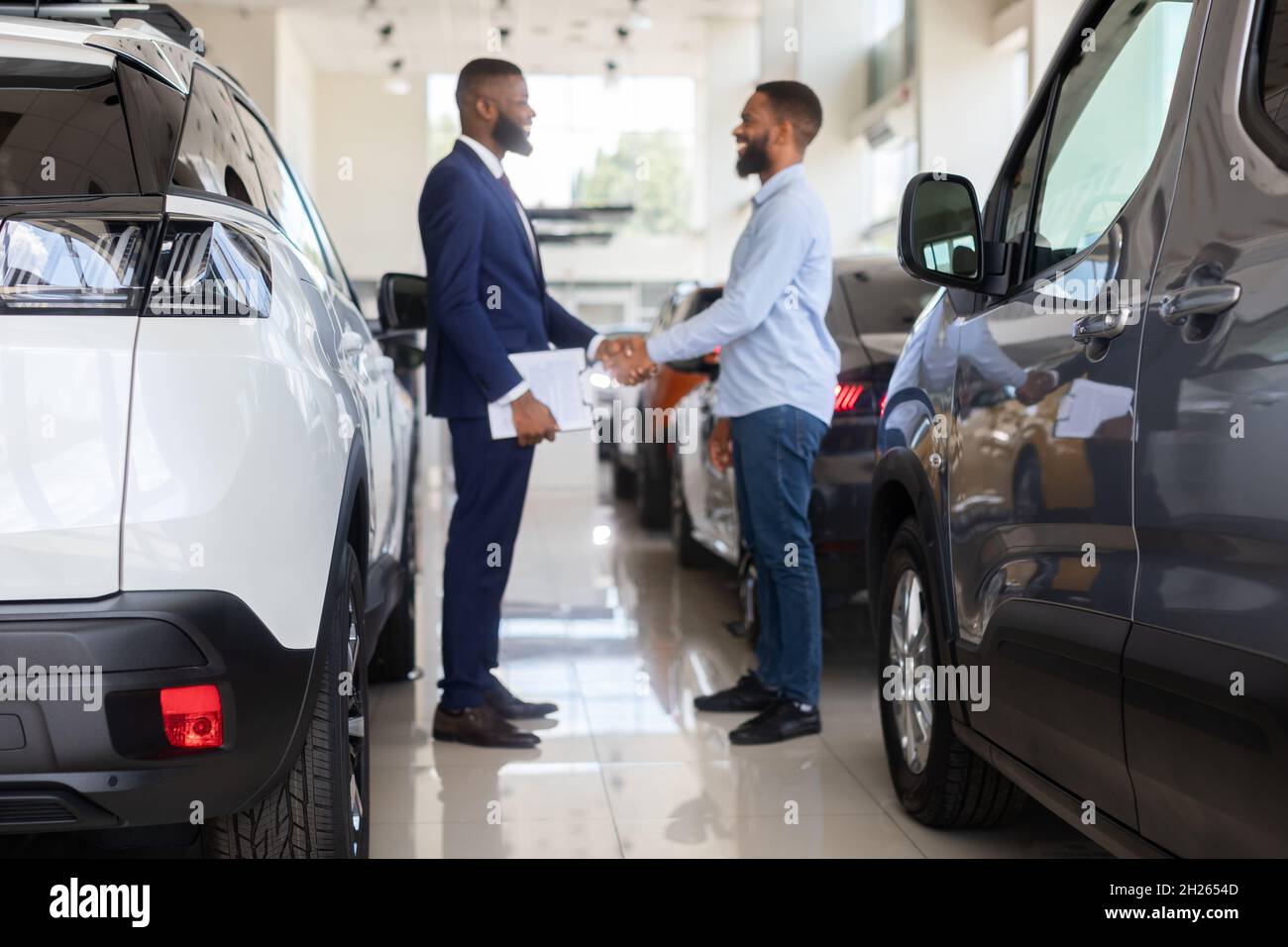 Auto Showroom Manager Shaking Hands With Male Customer After Successful ...