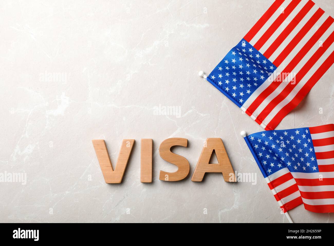 Flat lay composition with word VISA and flags of USA on gray background ...