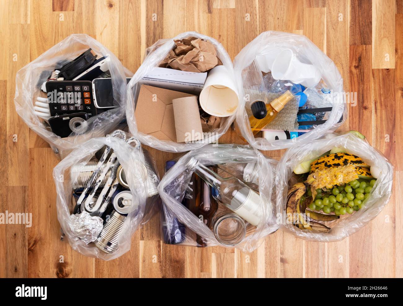 Top view photo of segregated waste materials laid on wooden background ...