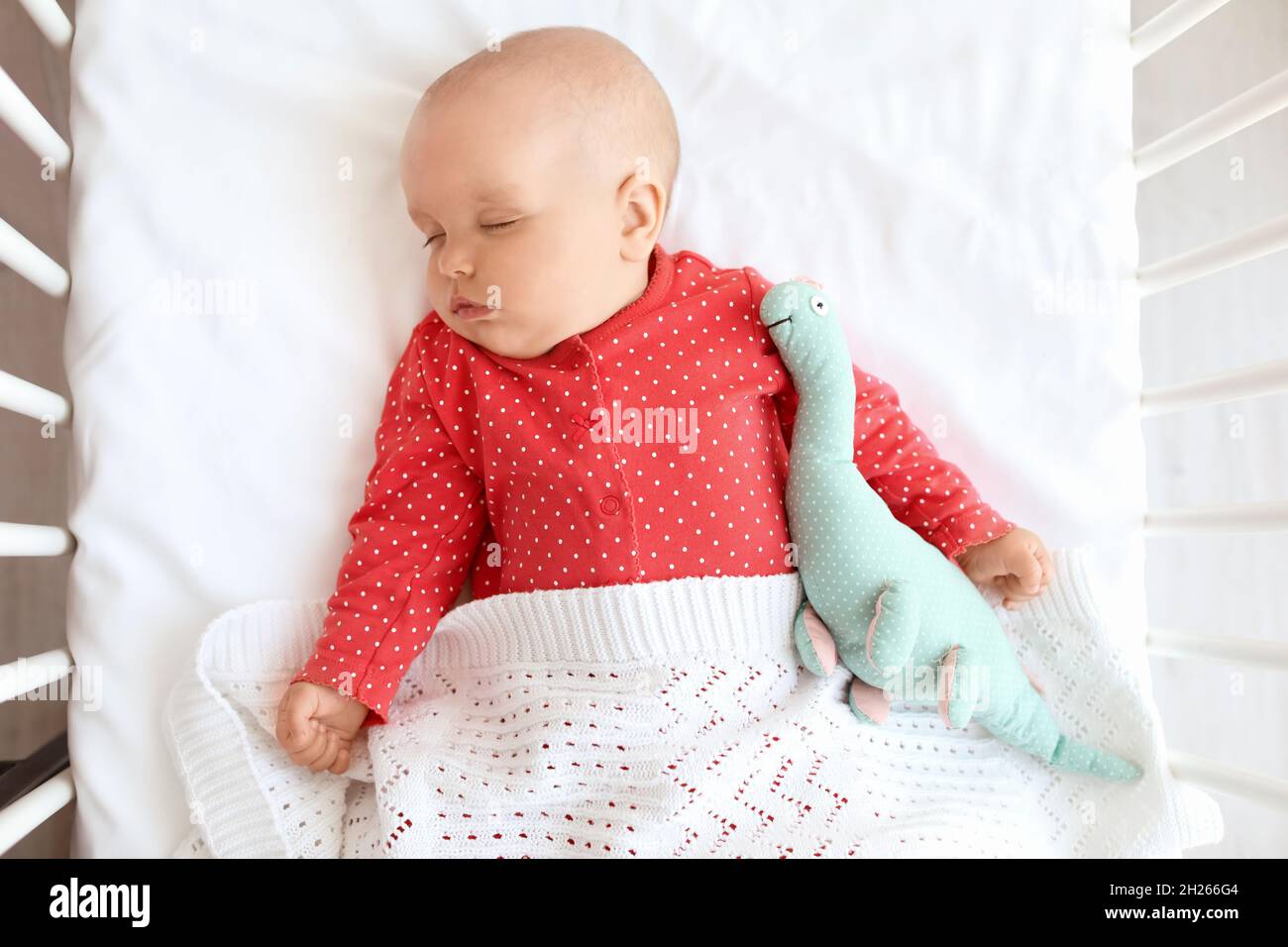 Cute baby girl sleeping in crib, top view Stock Photo - Alamy