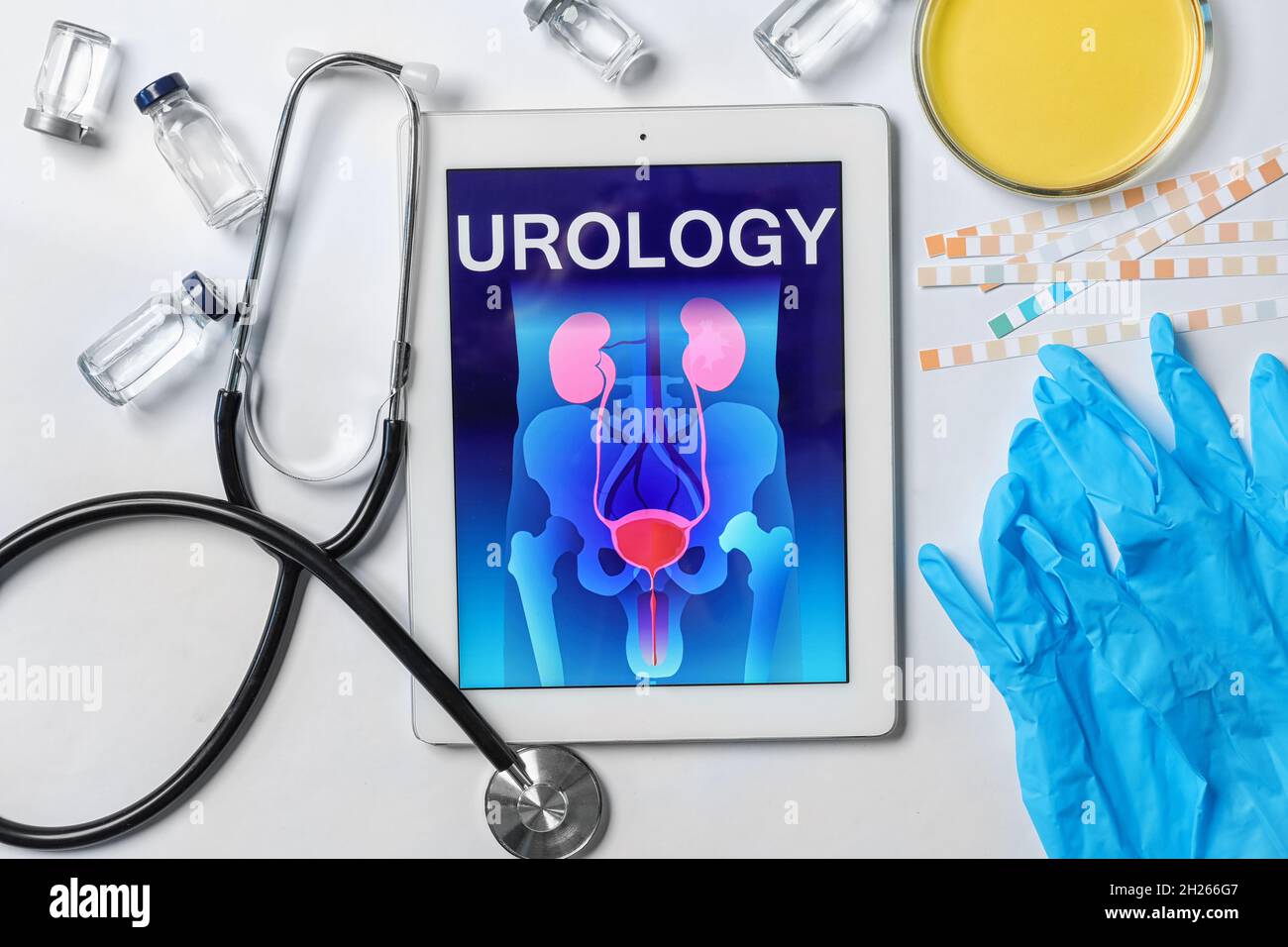 Flat lay composition with tablet, stethoscope and urine in dish on ...