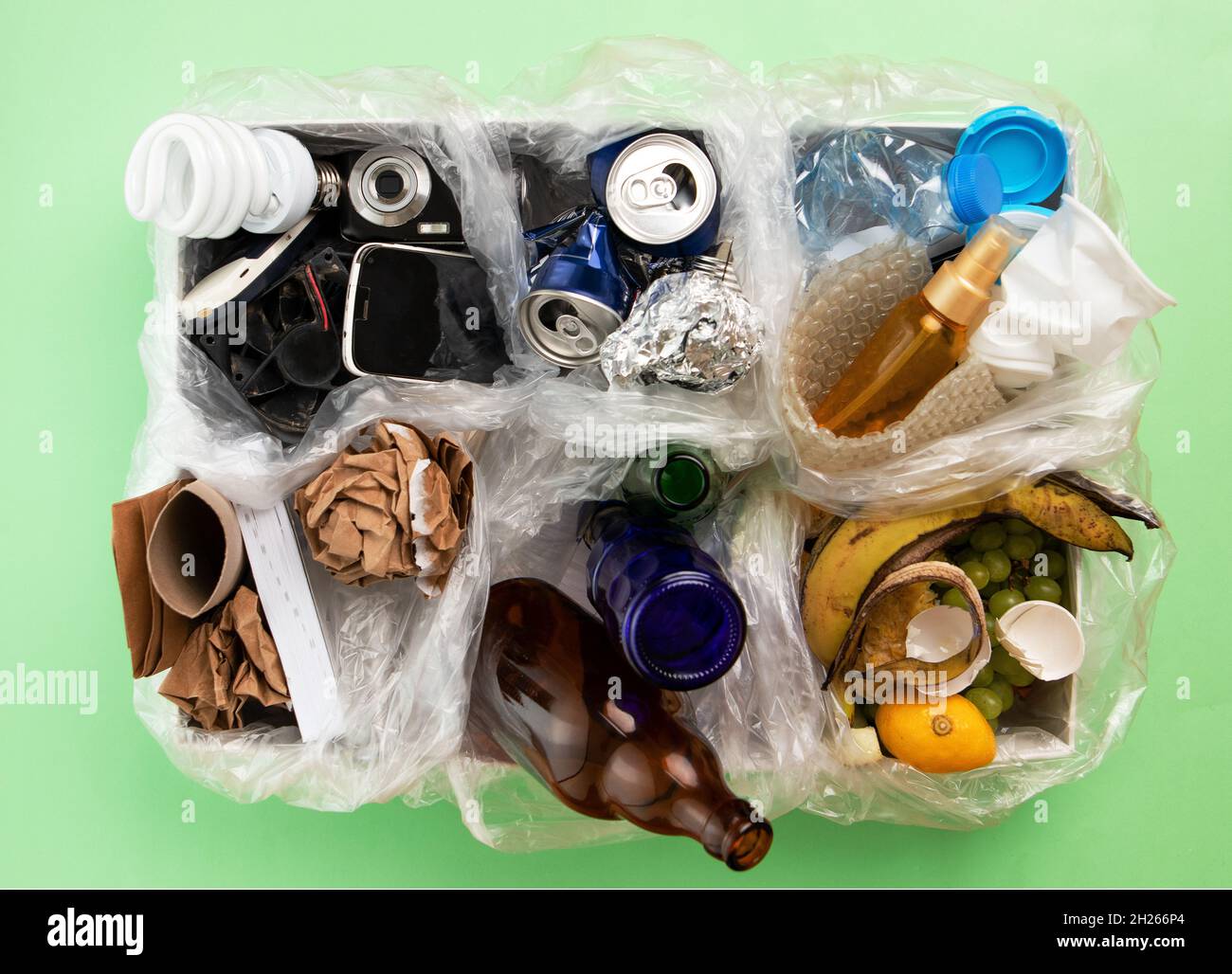 Top view photo of segregated waste materials laid on green isolated ...
