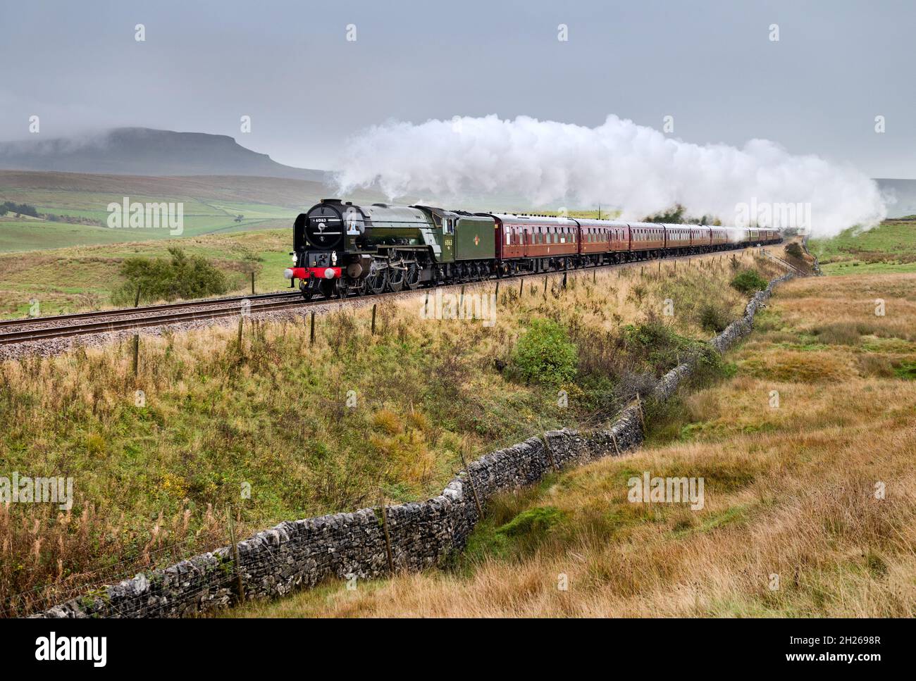 Under heavy rain clouds, steam locomotive 'Tornado' hauls a special ...