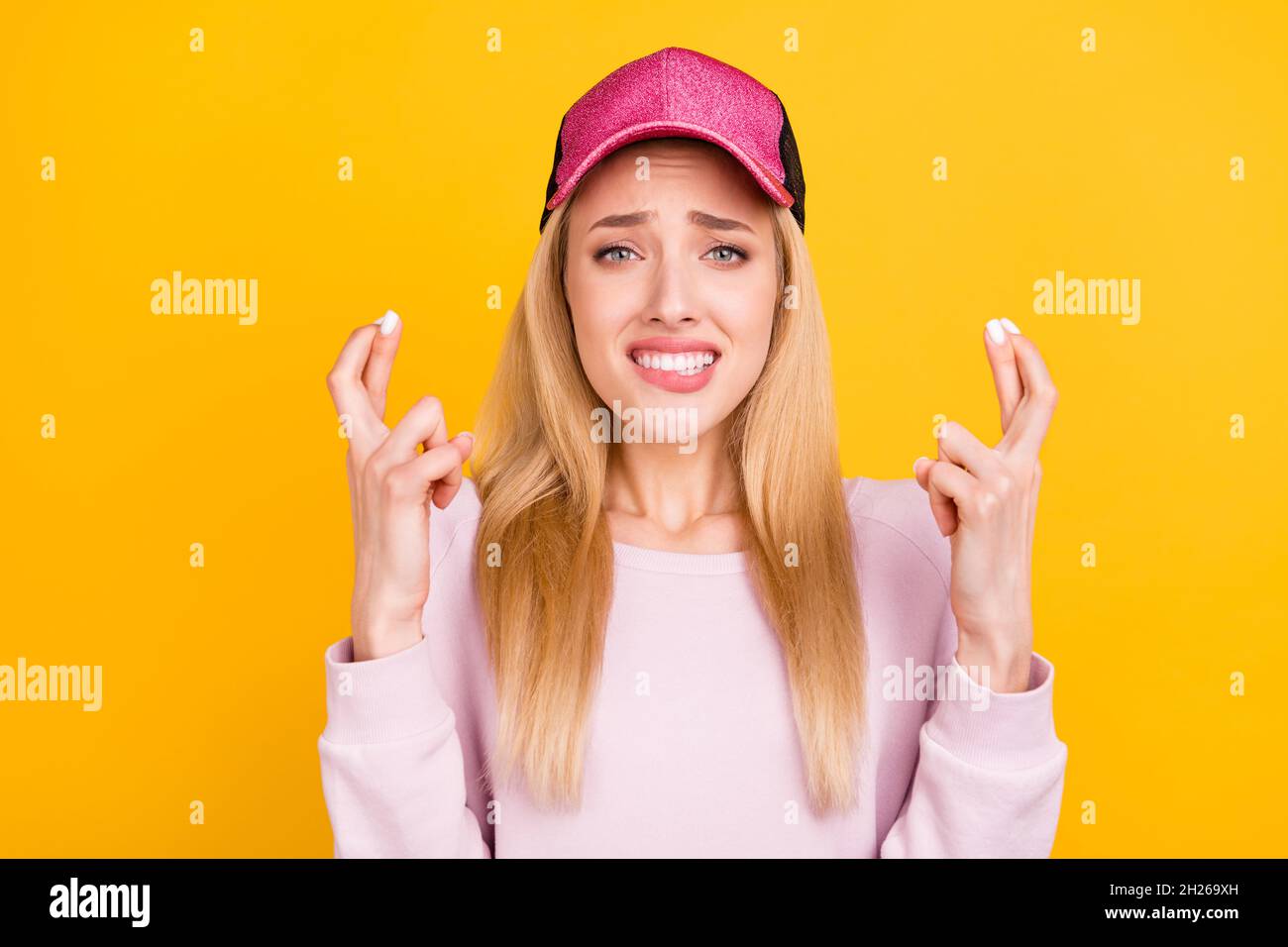 Photo portrait smiling woman biting lips crossed fingers isolated ...