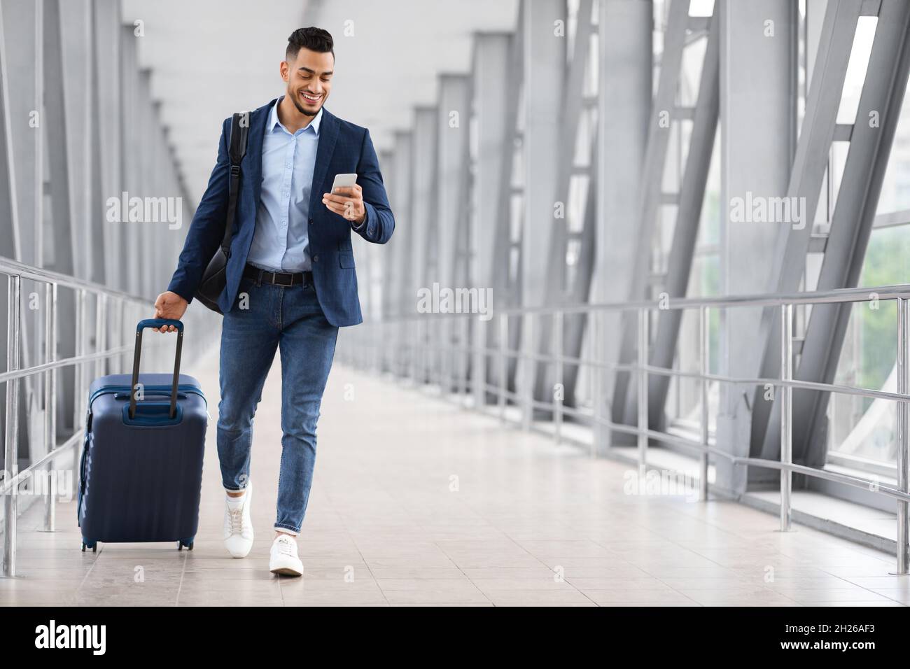 Online Check In. Handsome Arab Man Walking In Airport And Using ...