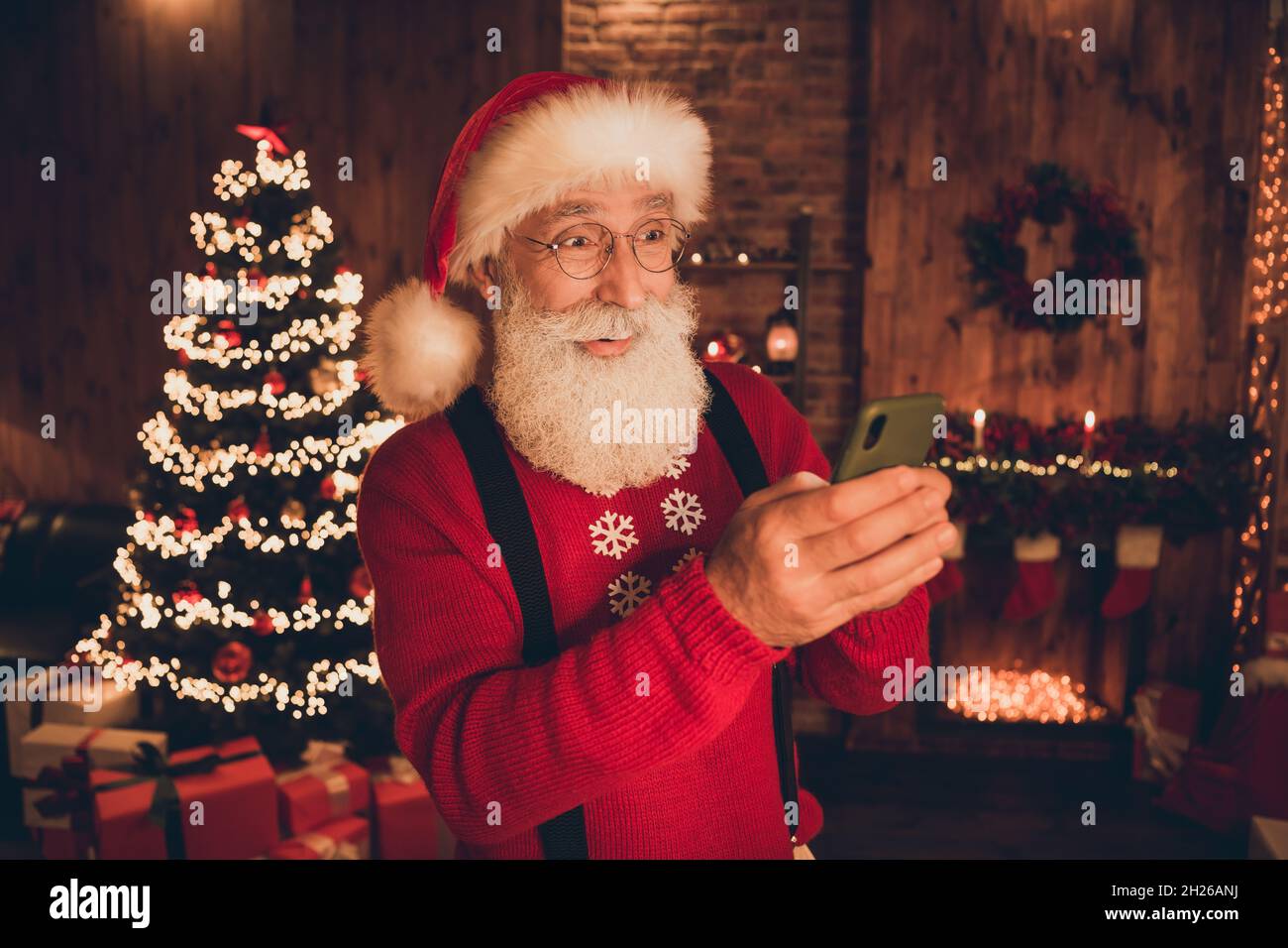 Photo portrait santa claus typing message using mobile phone smiling ...