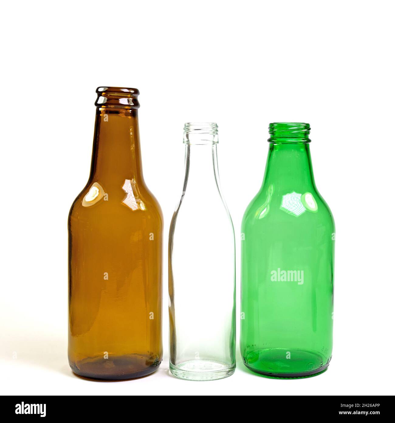 Various empty glass bottles against white background Stock Photo - Alamy