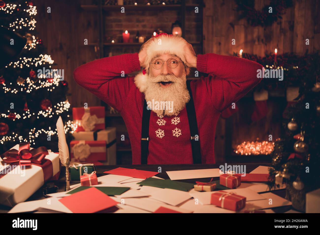 Photo of surprised shocked santa claus sit workspace open mouth wear ...