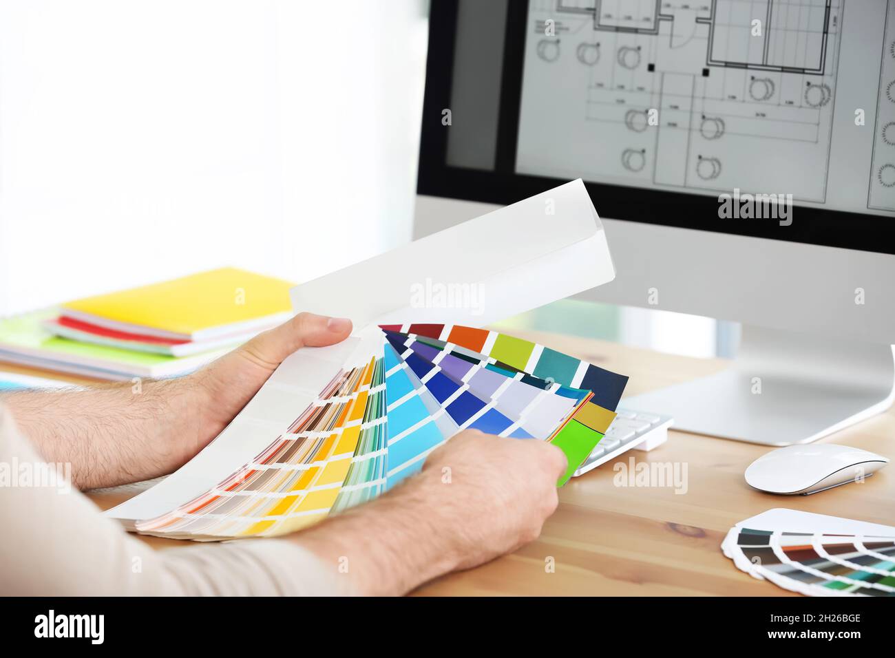 Designer with paint color palette samples at table, closeup Stock Photo ...