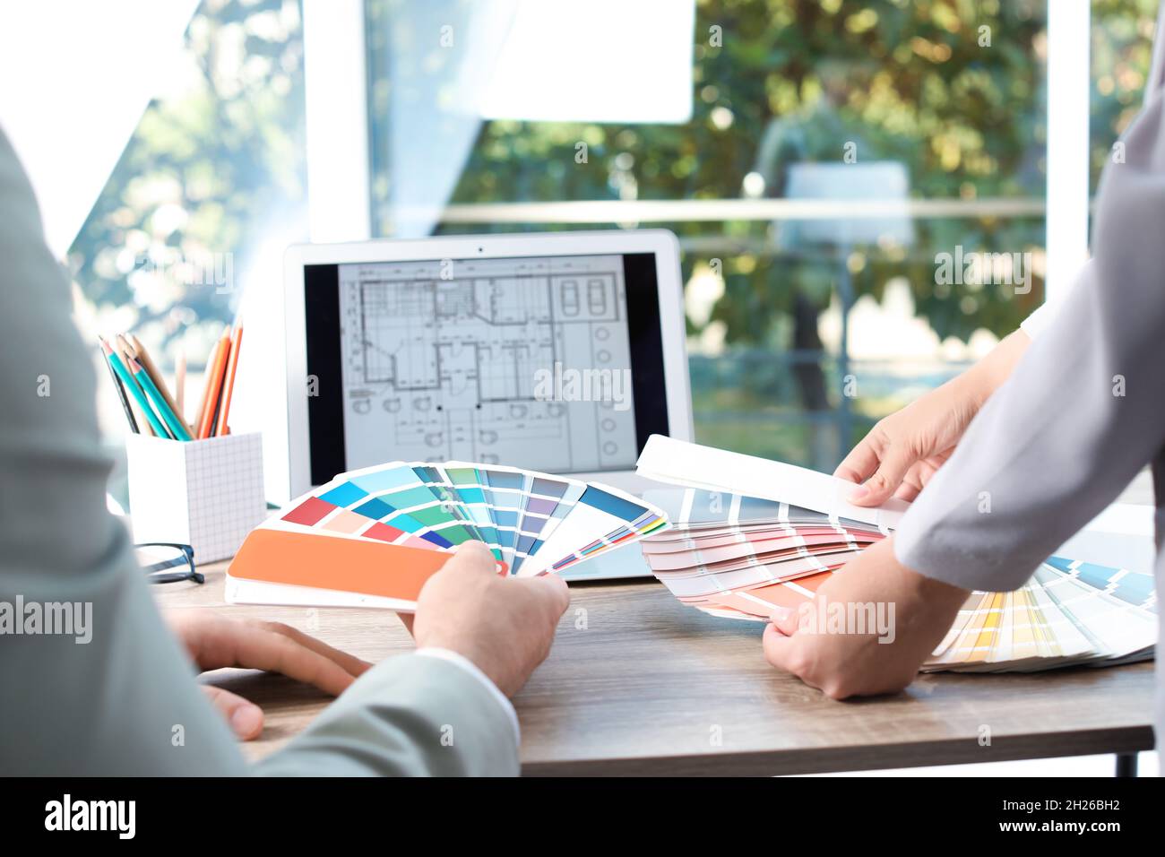 Team of designers working with color palettes at office table, closeup ...
