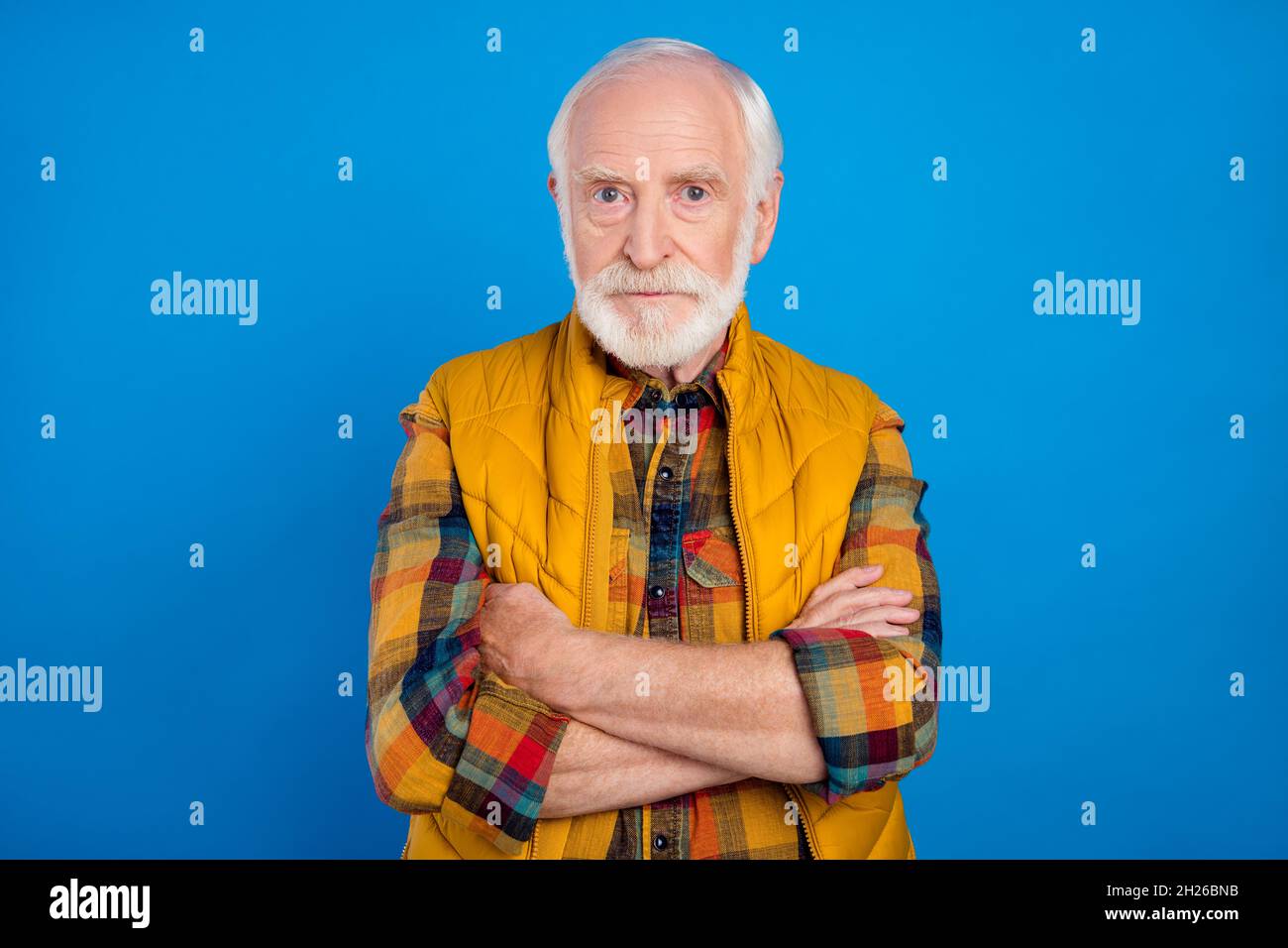 Portrait of attractive content serious grey-haired man folded arms ...
