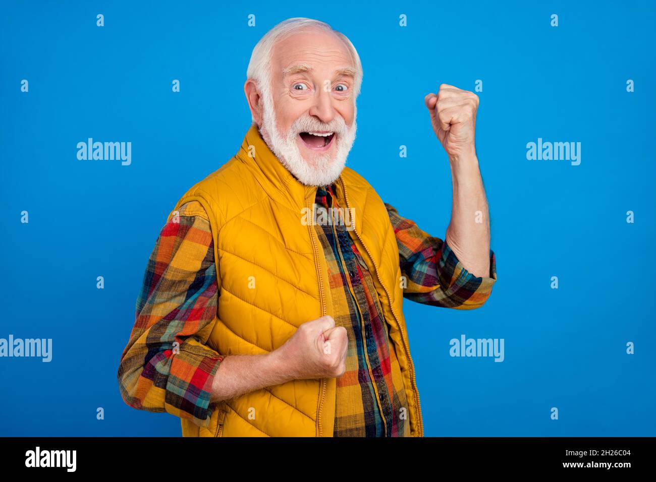Portrait of attractive cheerful grey-haired man rejoicing having fun ...