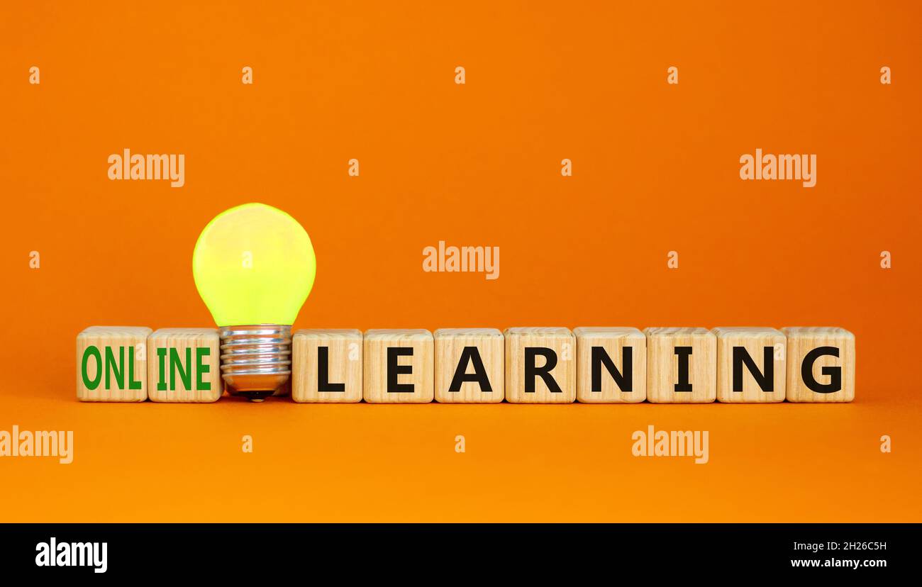 Online learning symbol. Wooden cubes with words online learning. Yellow ...