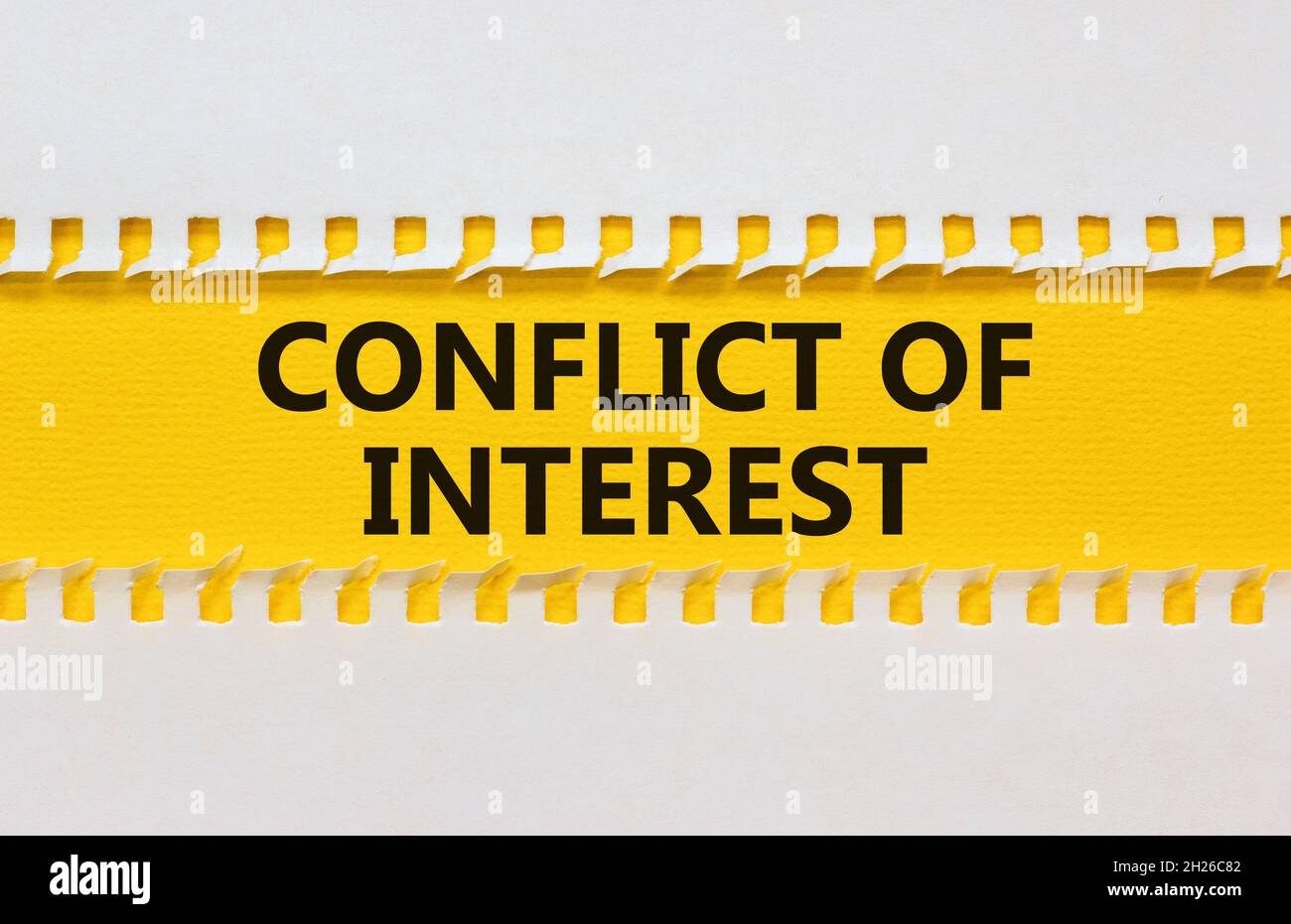Conflict of interest symbol. White and yellow paper with words ...