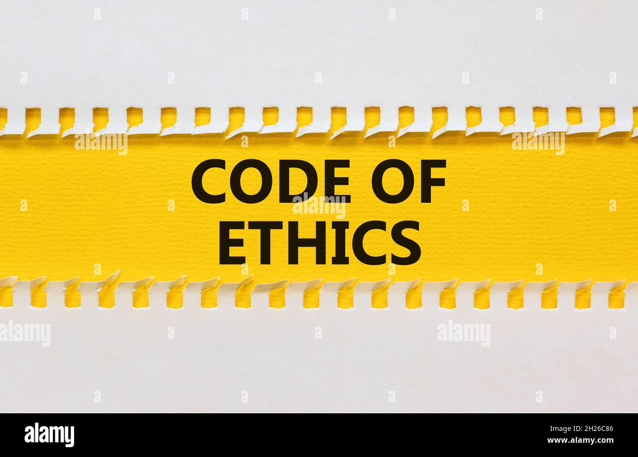 Code of ethics symbol. White and yellow paper with words 'Code of ...