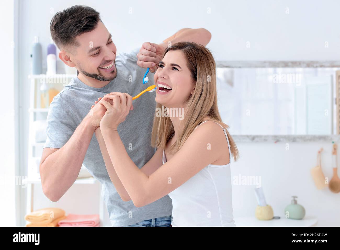 Young couple brushing teeth together in bathroom Stock Photo - Alamy