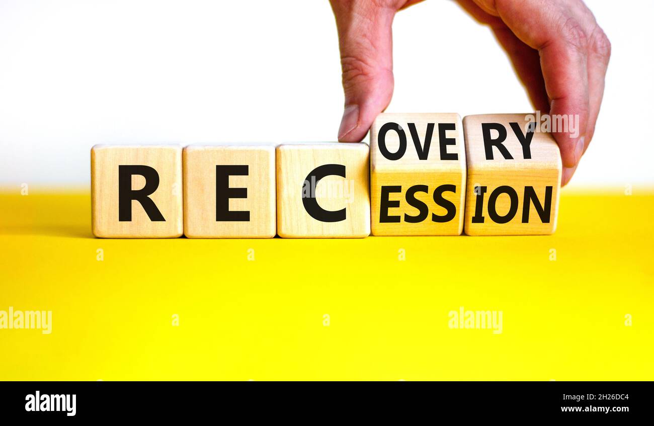 Recovery and recession symbol. Businessman turns cubes and changes the ...