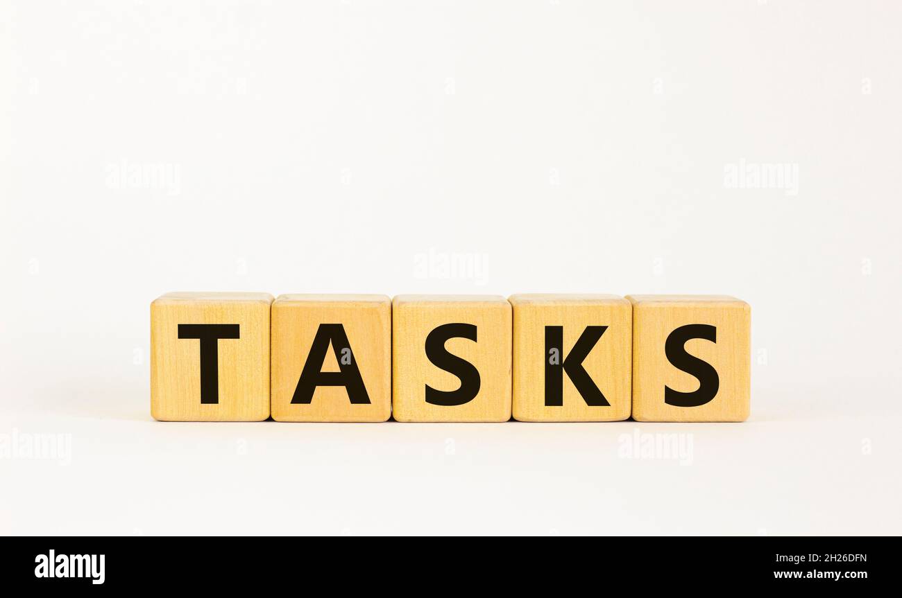 Tasks symbol. The concept word 'tasks' on wooden cubes on a beautiful ...