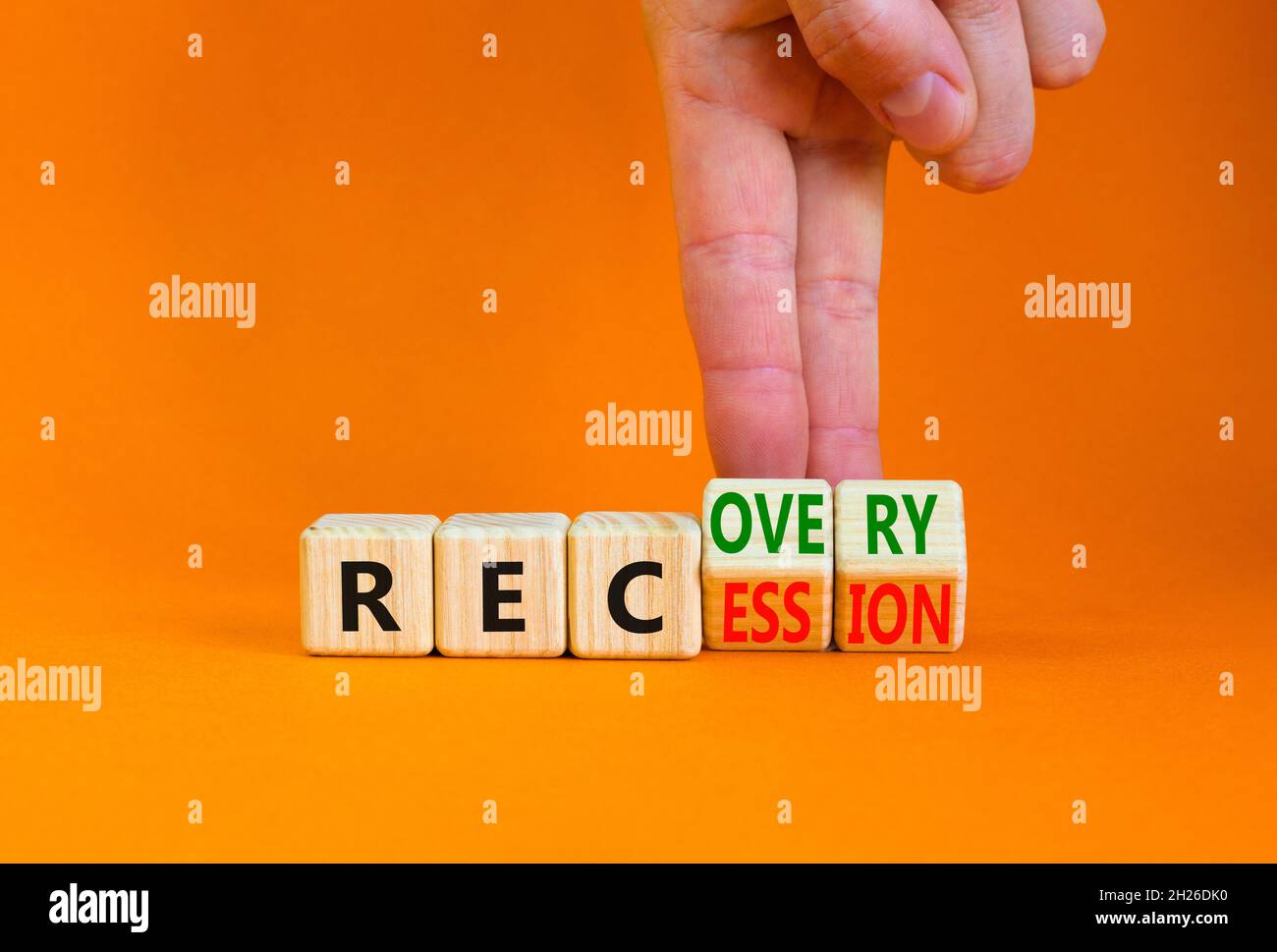 Recovery and recession symbol. Businessman turns cubes and changes the ...