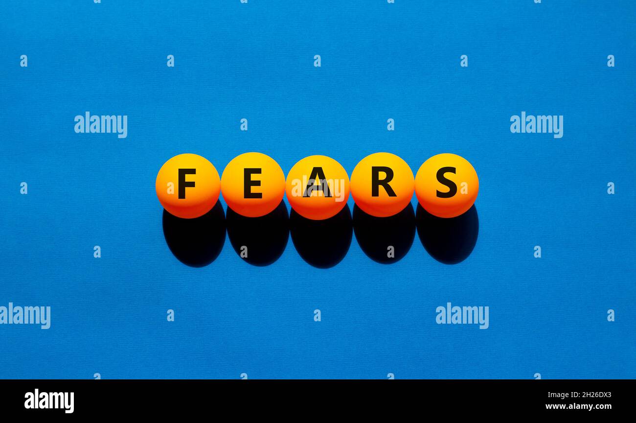 Fears symbol. The concept word 'fears' on orange table tennis balls ...
