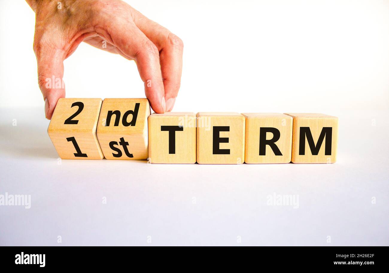 First or second term symbol. Businessman turns wooden cubes and changes ...